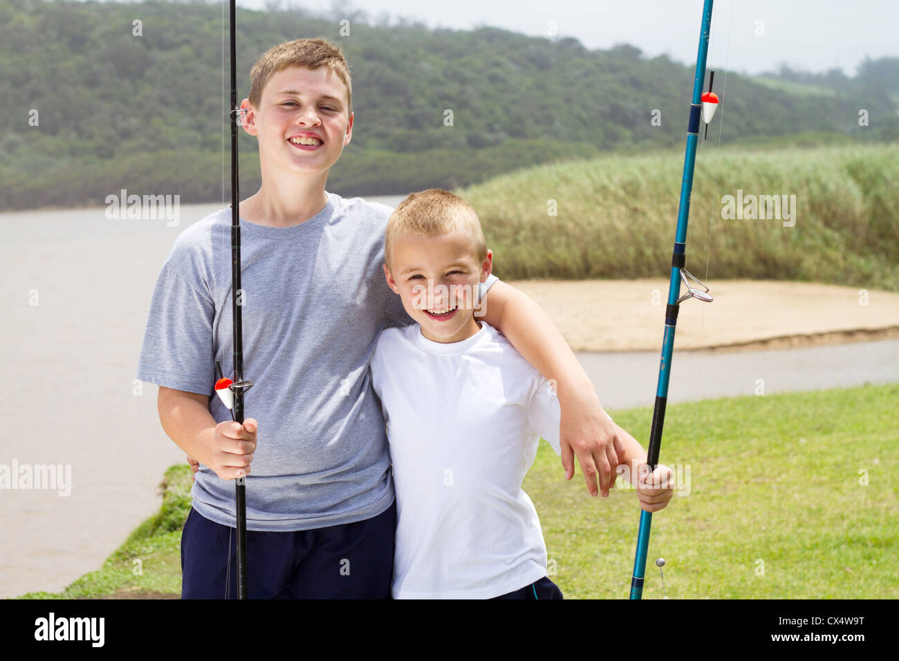 portrait of two little brothers fishing by the lake Stock Photo - Alamy