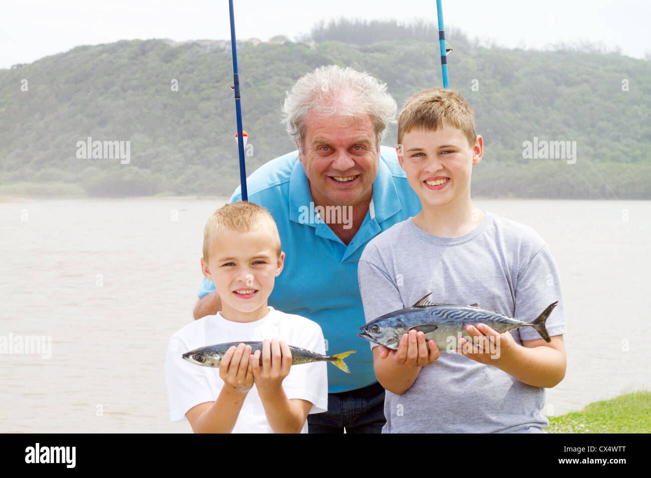 catch of the day: happy grandpa and grandson showing two fish Stock ...
