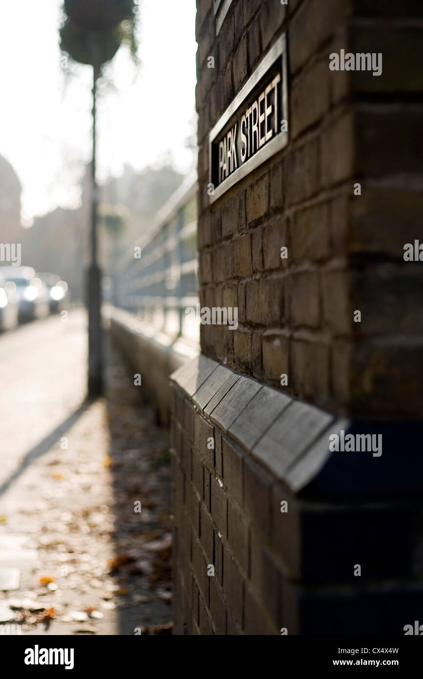 Wall with street name and view of sunlit street in distance Stock Photo ...