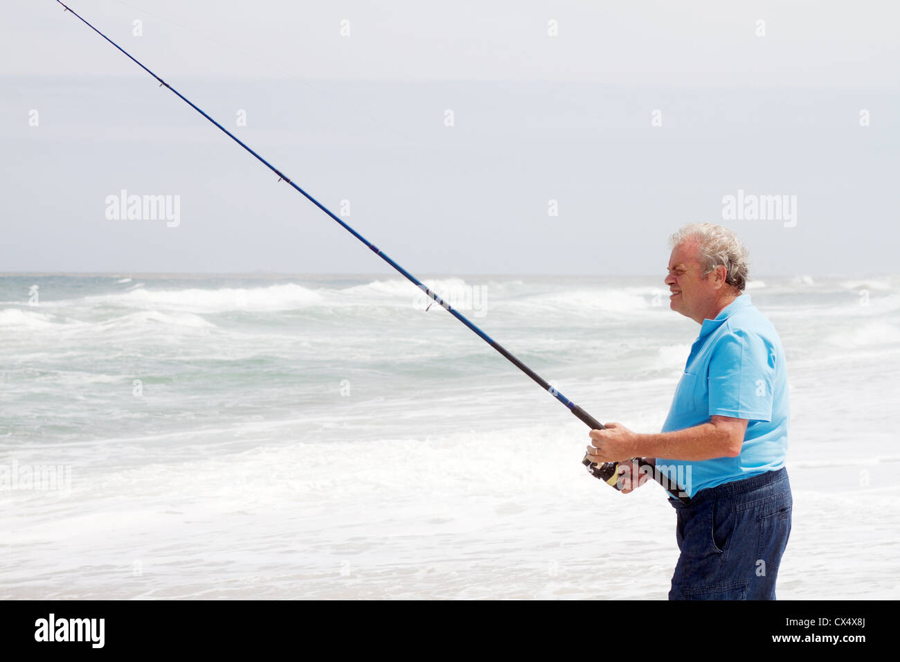 retired senior man fishing on beach alone Stock Photo - Alamy
