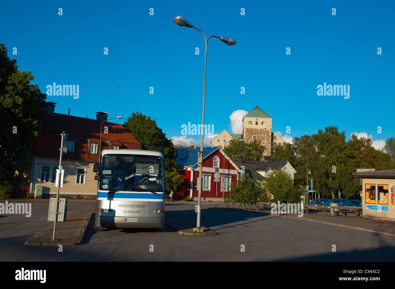 Long distance bus station at passenger port with castle in background ...
