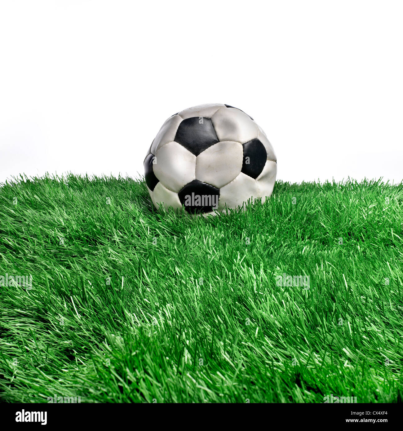 Deflated football ball on grass Stock Photo - Alamy
