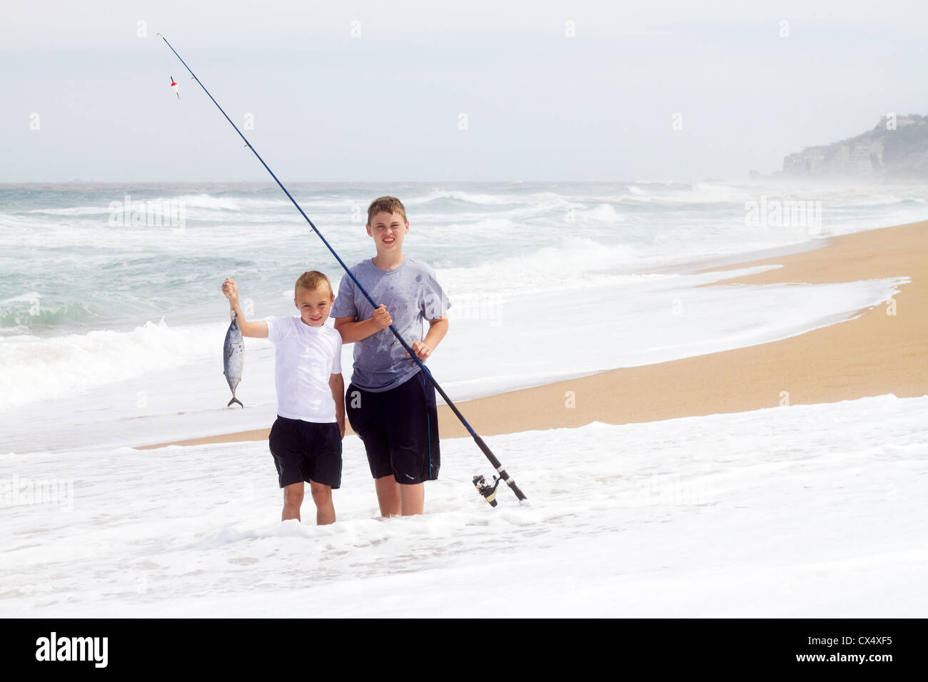 Two boys holding two fish hi-res stock photography and images - Alamy