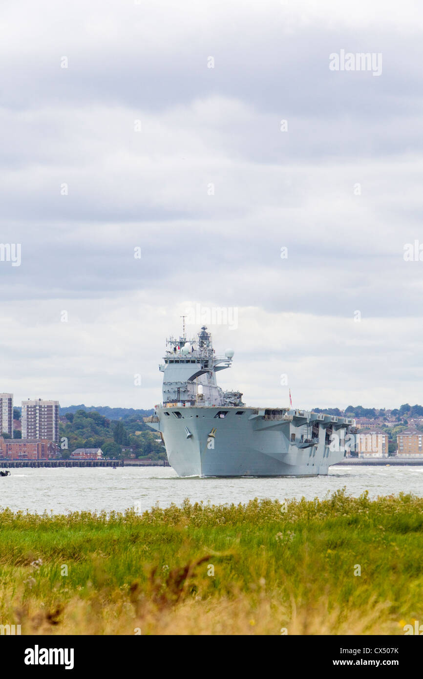 HMS Ocean, amphibious assault ship, making way down River Thames after ...