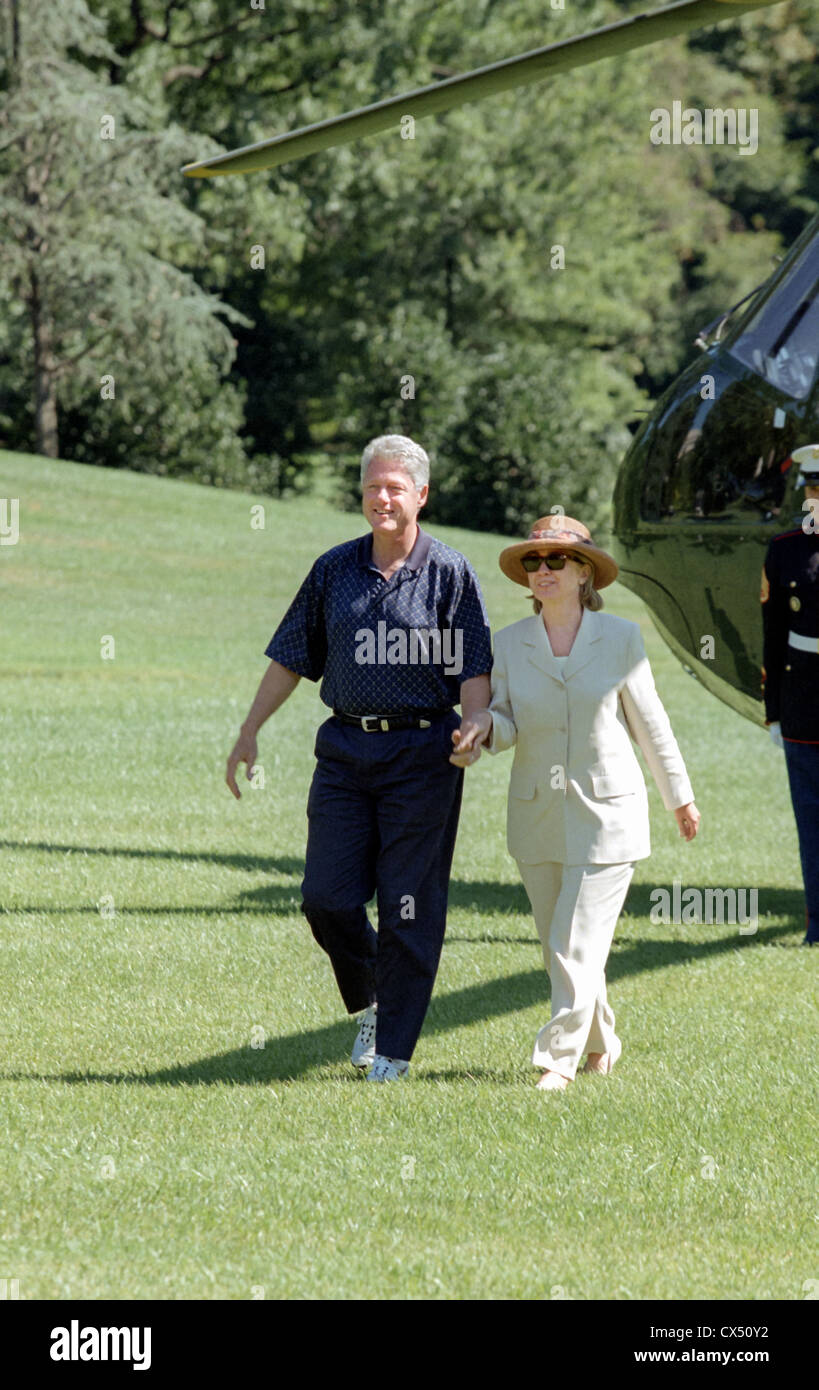 President Bill Clinton and first lady Hillary Clinton return from a ...