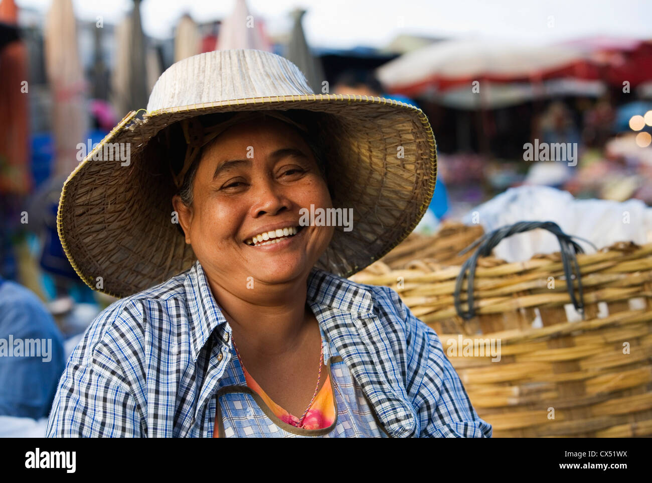 An Isan woman in traditional woven hat in the central market. Surin ...