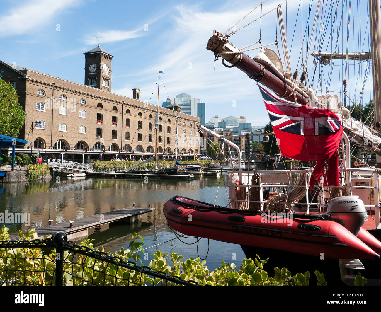 A yacht and warehouses in St. Katherine Docks, London by Tower Bridge ...