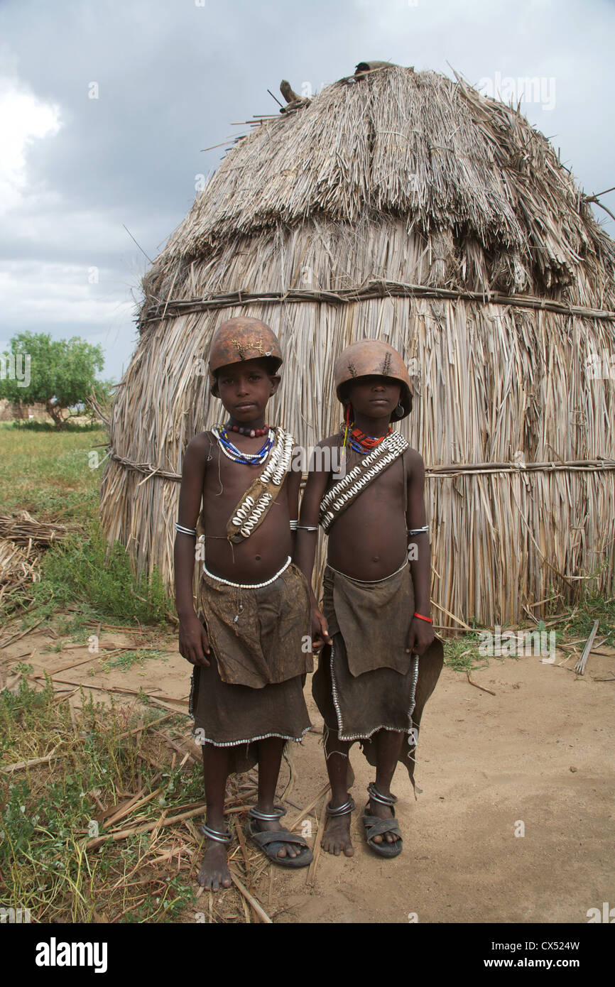 Two young children in front of oval traditional hut, Erbore, Omo Valley ...