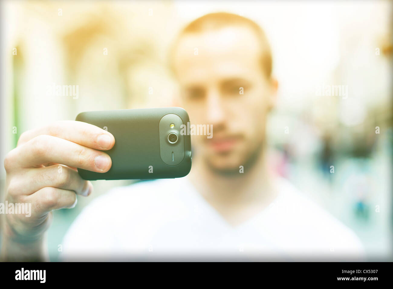 Urban photographer with mobila phone make photo on street Stock Photo ...