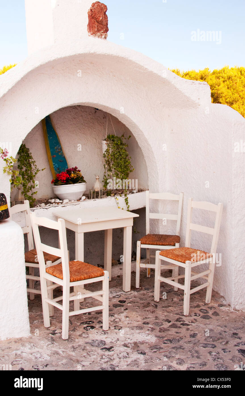 Chairs and small table sitting just off pedestrian street, Oia ...