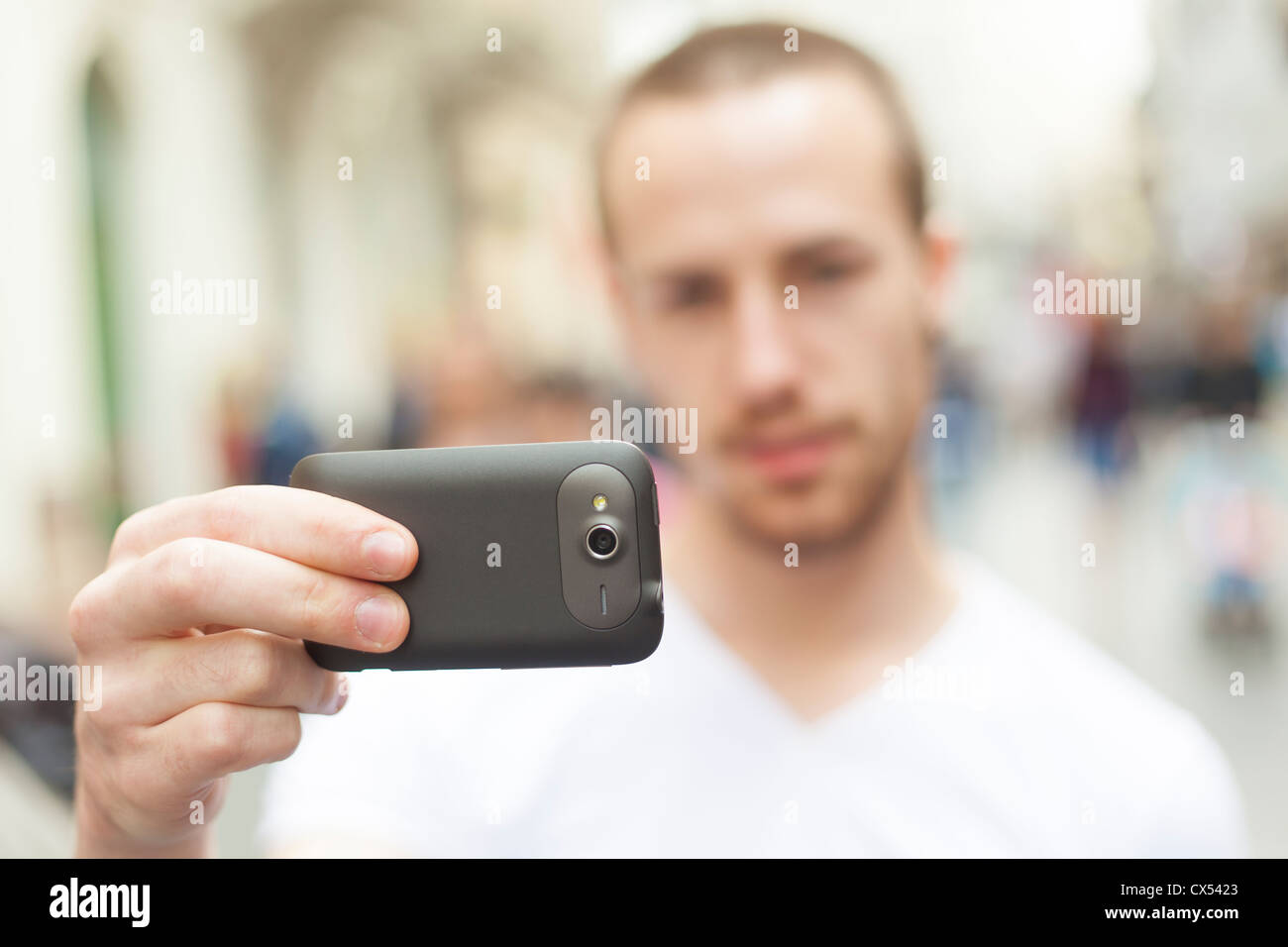 Urban photographer with mobile phone make photo on street Stock Photo ...