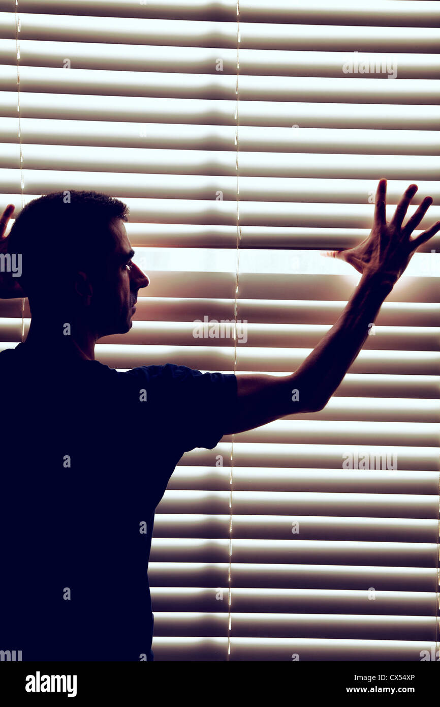 Man opening window blinds hi-res stock photography and images - Alamy