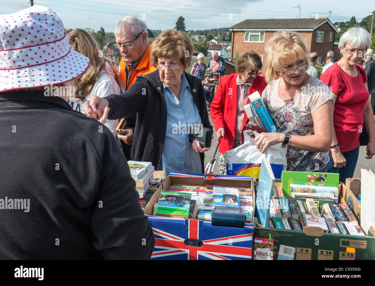 BOOK STALL WITH CUSTOMERS BROWSING AT CHURCH FETE IN GLOUCESTERSHIRE ...