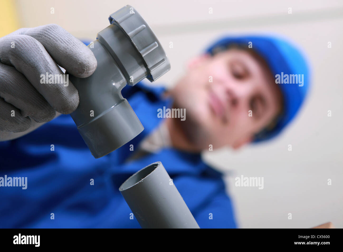 Plumber fitting plastic pipe Stock Photo - Alamy