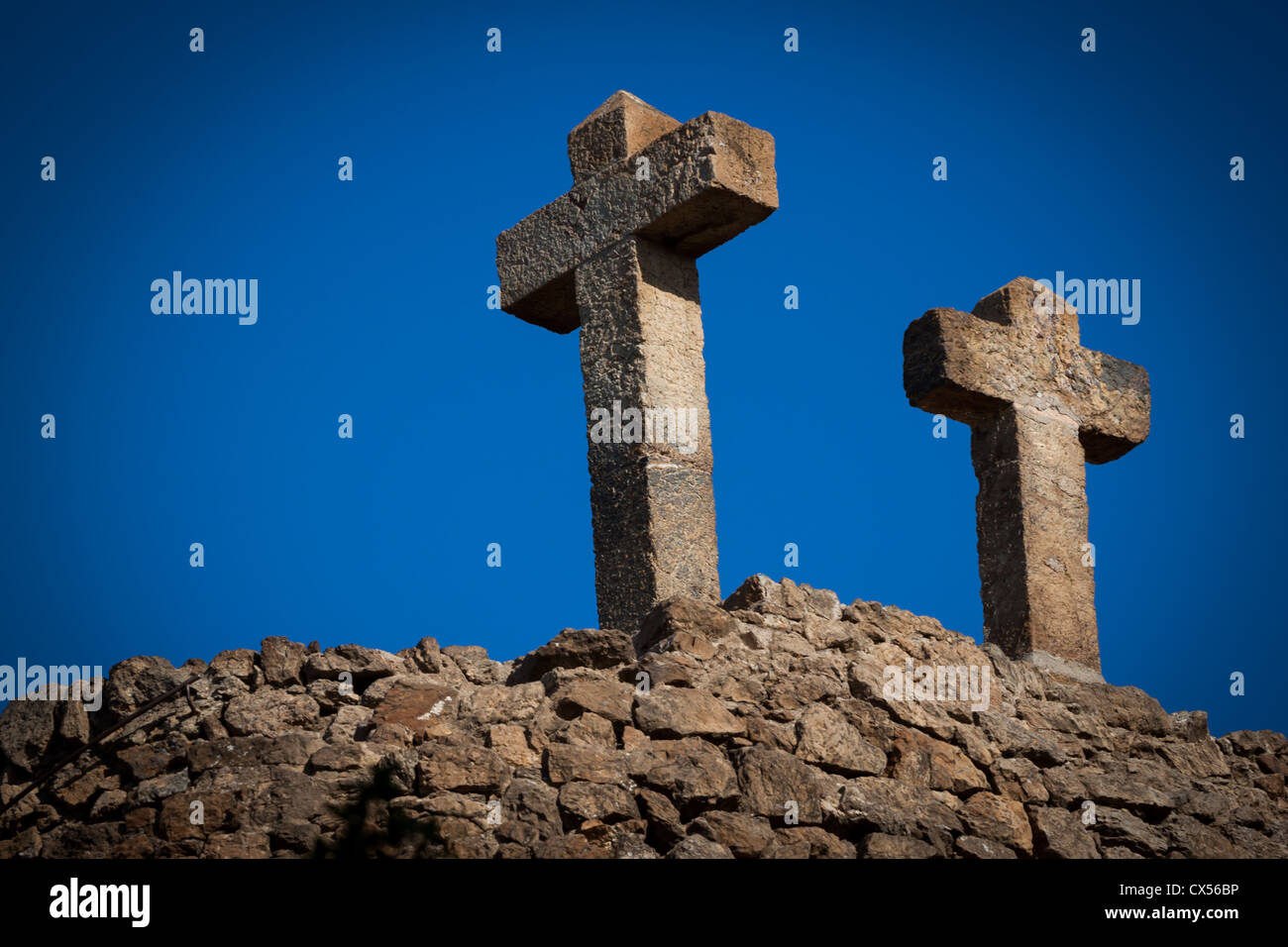 Two old stone crosses in Barcelona over blue sky Stock Photo - Alamy