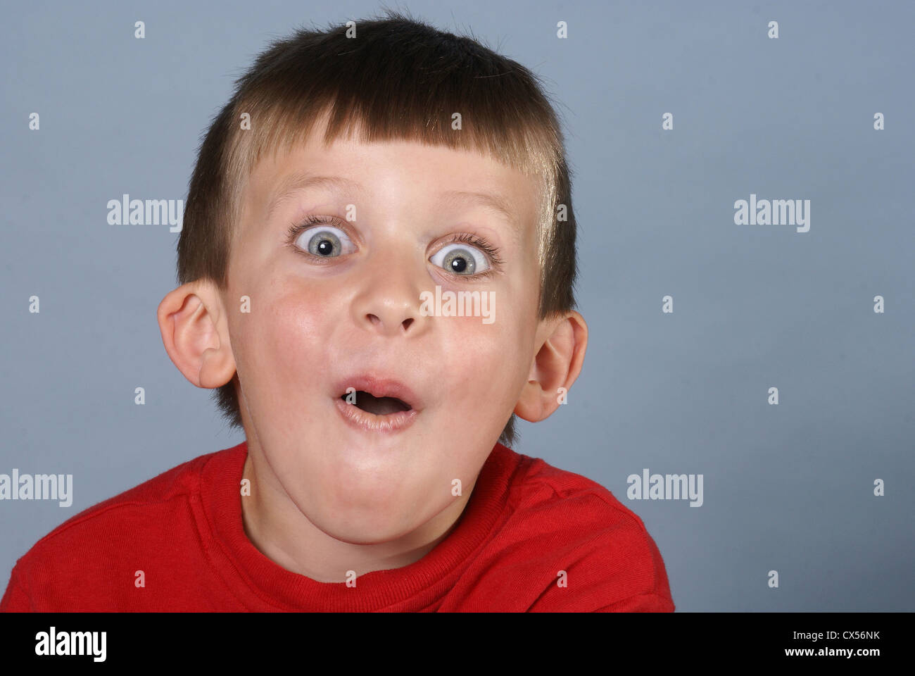 Wide eyed boy stares astonished straight ahead Stock Photo - Alamy