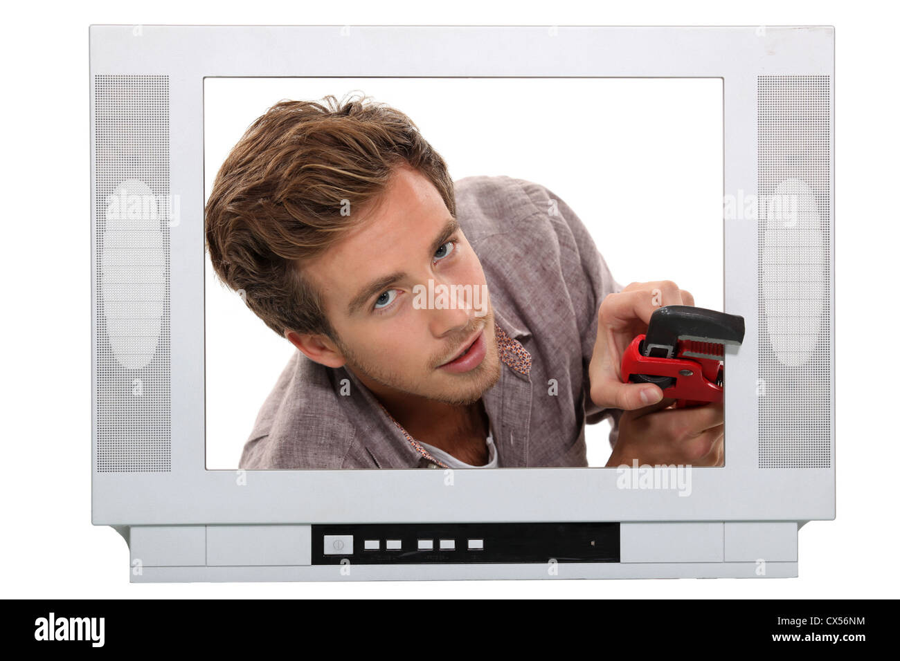 young man with pliers behind a television screen Stock Photo - Alamy