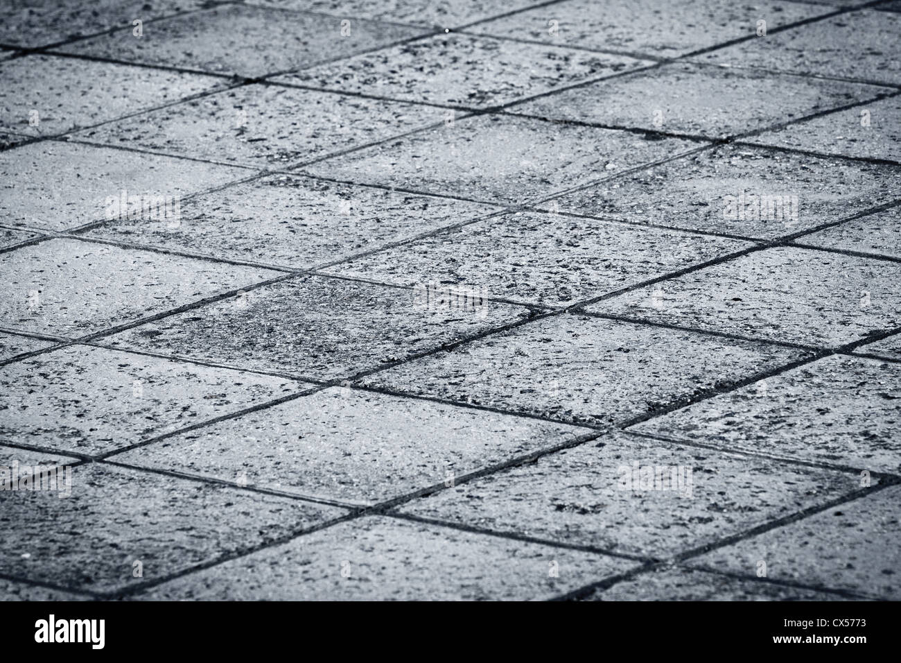 Rock tiled paved road background pattern Stock Photo - Alamy