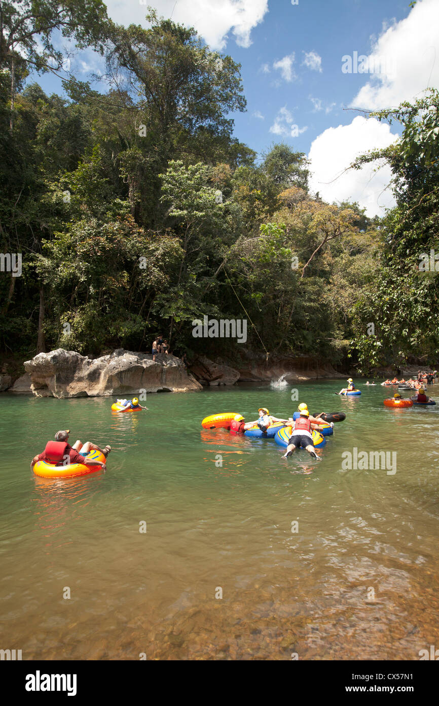 Tourist wave and river tubing in the Cayo District in Central America ...
