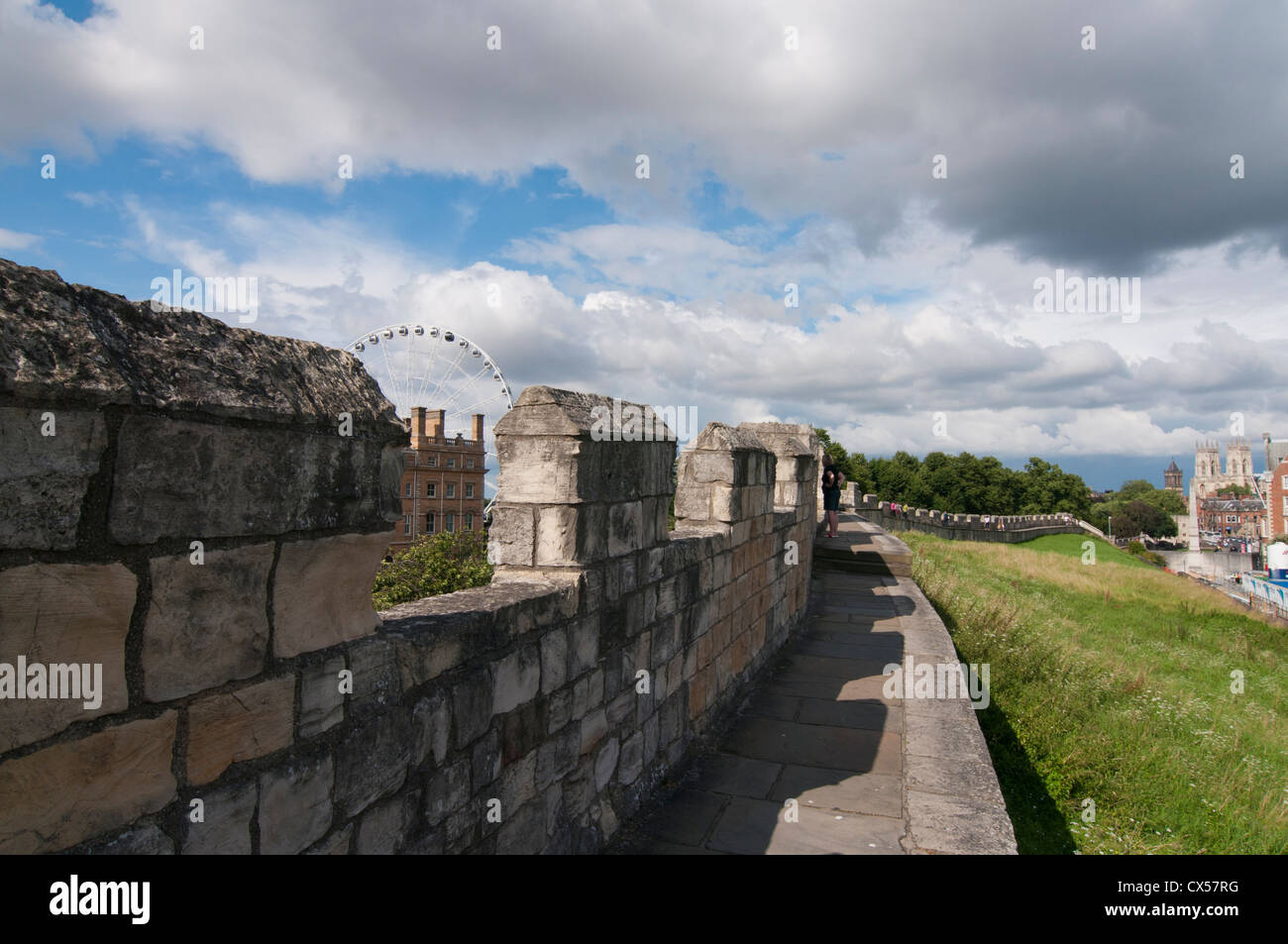 Looking along York City Walls with Wheel of York in the background ...