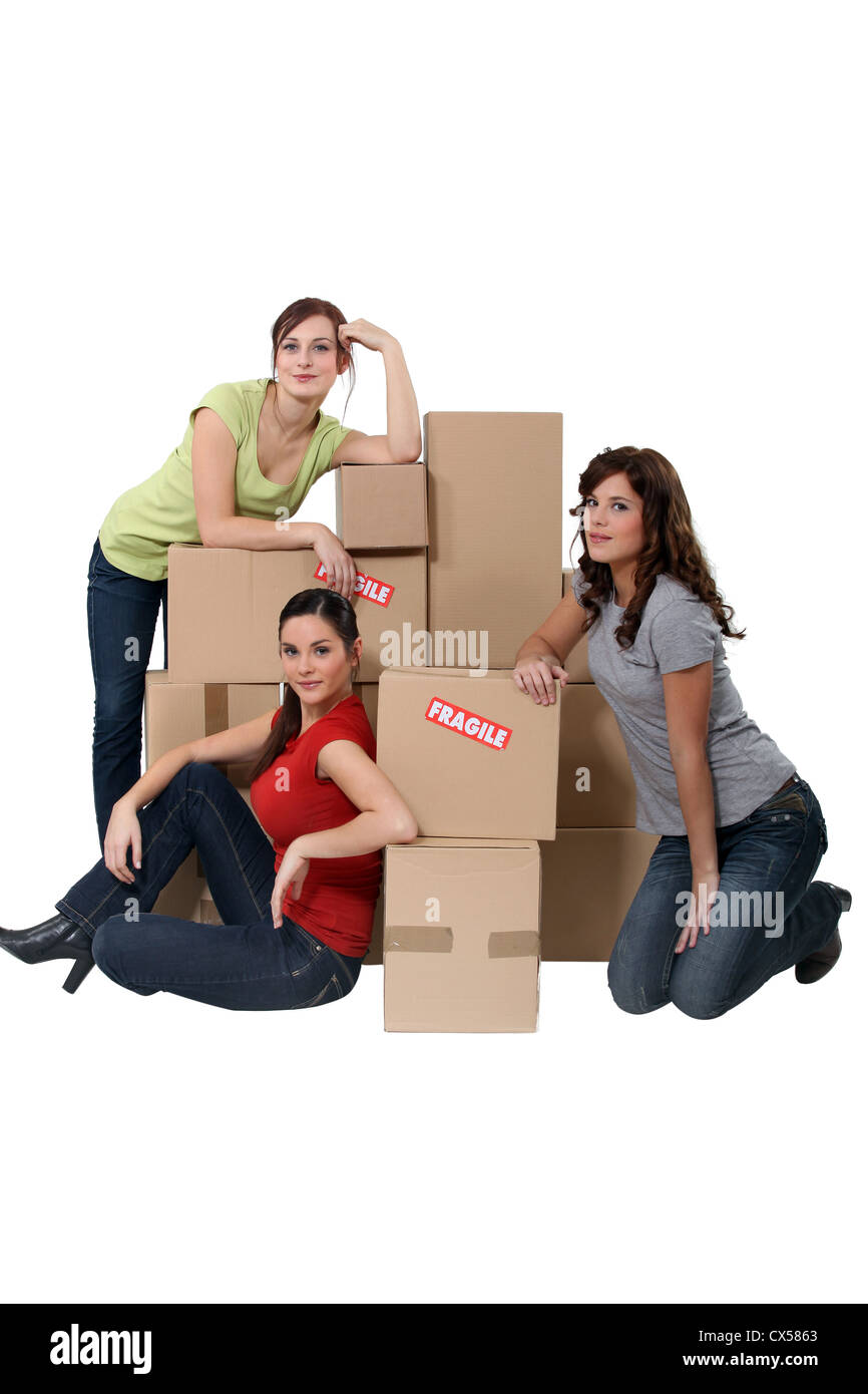 Three women moving house Stock Photo - Alamy