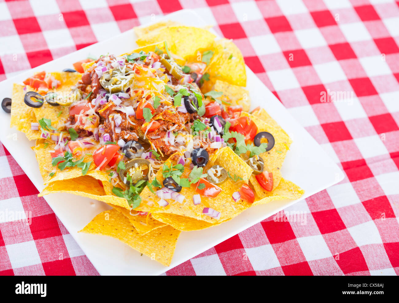 Cheesy Nachos on a Red Checkered Tablecloth Stock Photo - Alamy
