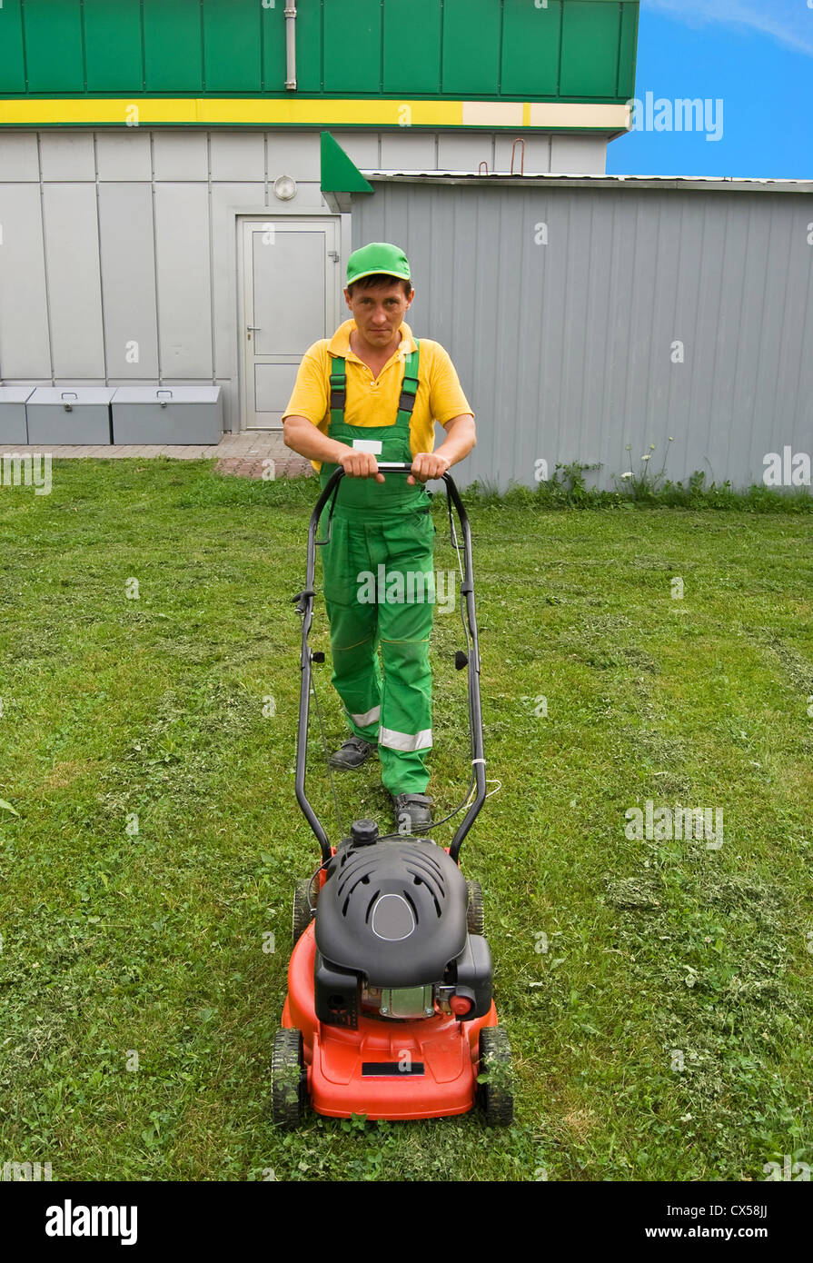 a men mows a lawn a mower Stock Photo - Alamy