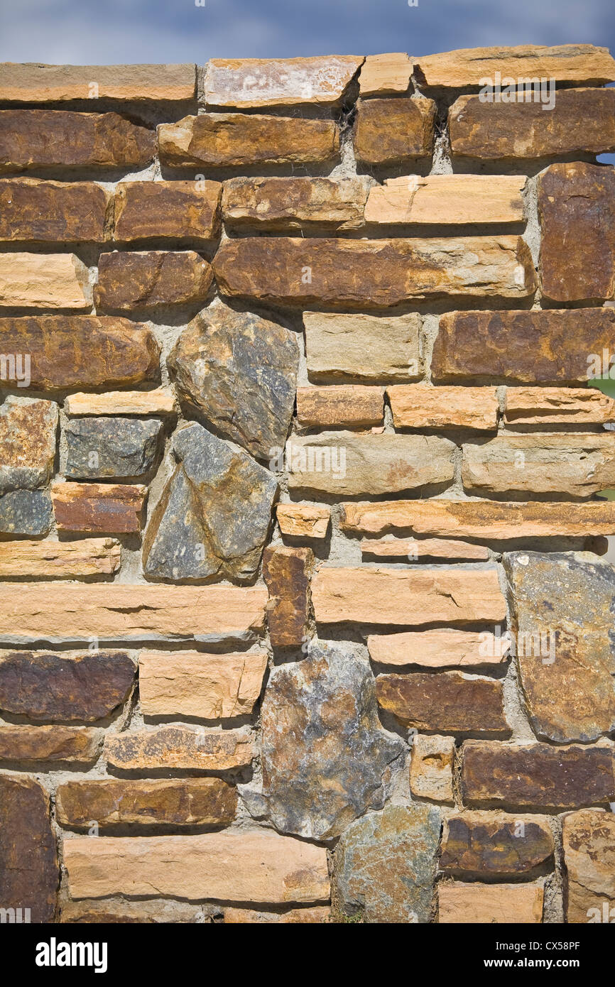 Stone wall of various shapes and colors of stones Stock Photo - Alamy