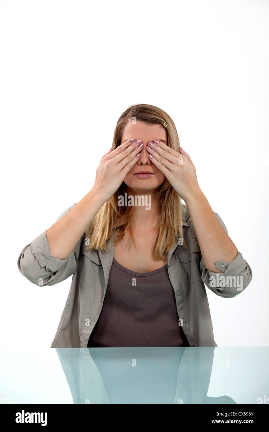 Woman covering her eyes Stock Photo - Alamy
