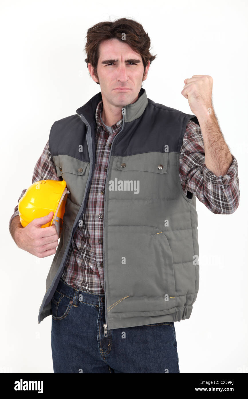 Angry builder waving fist Stock Photo - Alamy