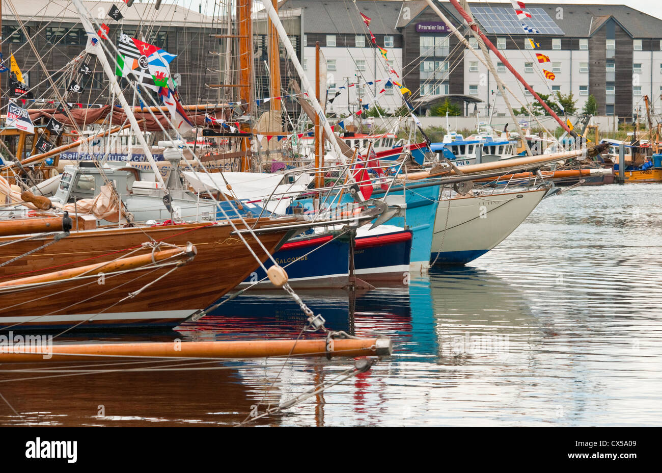 Old wooden sailing vessels bedecked and festooned in flags and bunting ...