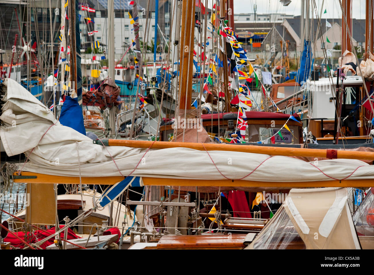 Old wooden sailing vessels bedecked and festooned in flags and bunting ...