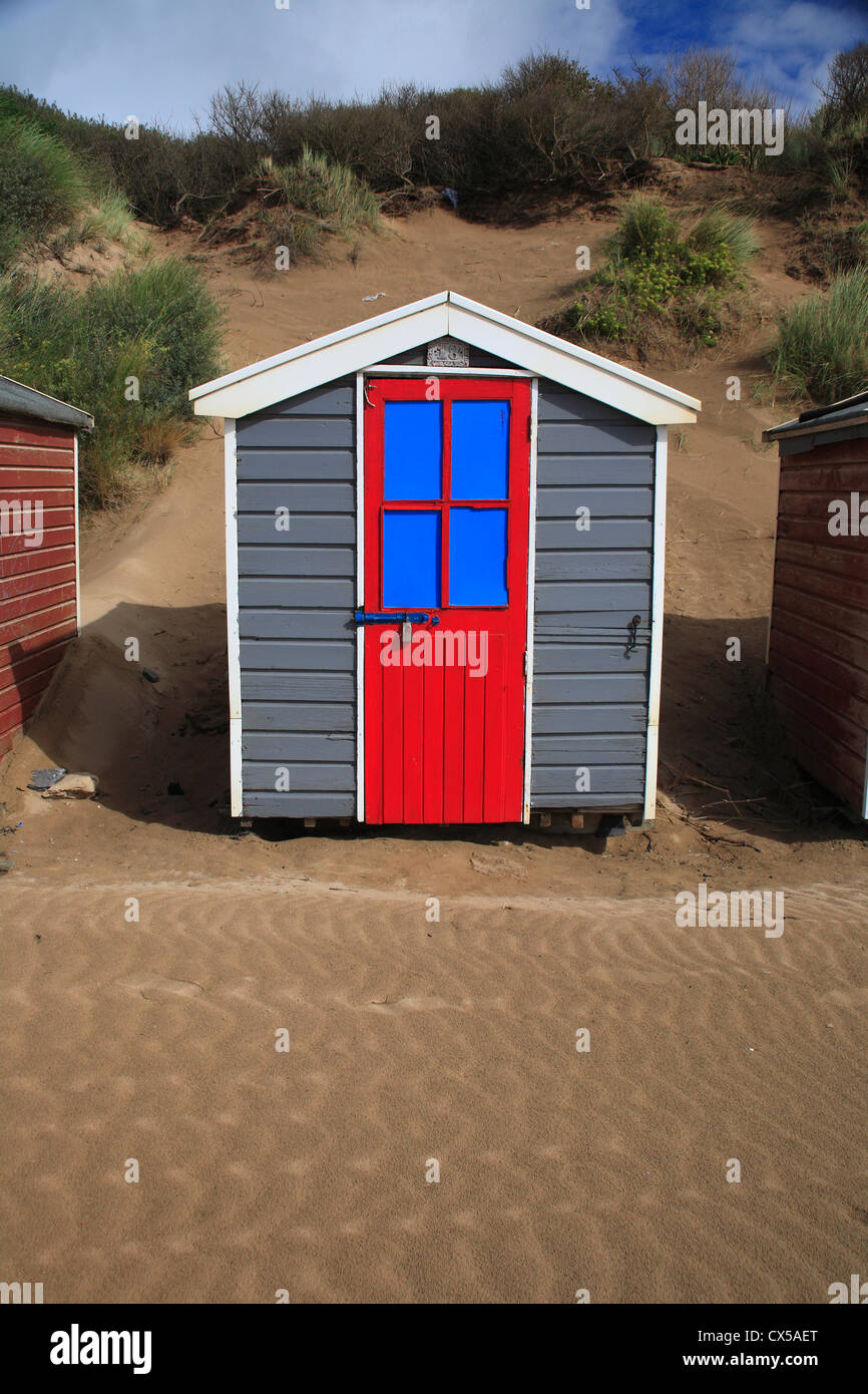 Single brightly coloured beach hut on sandy English beach Stock Photo ...