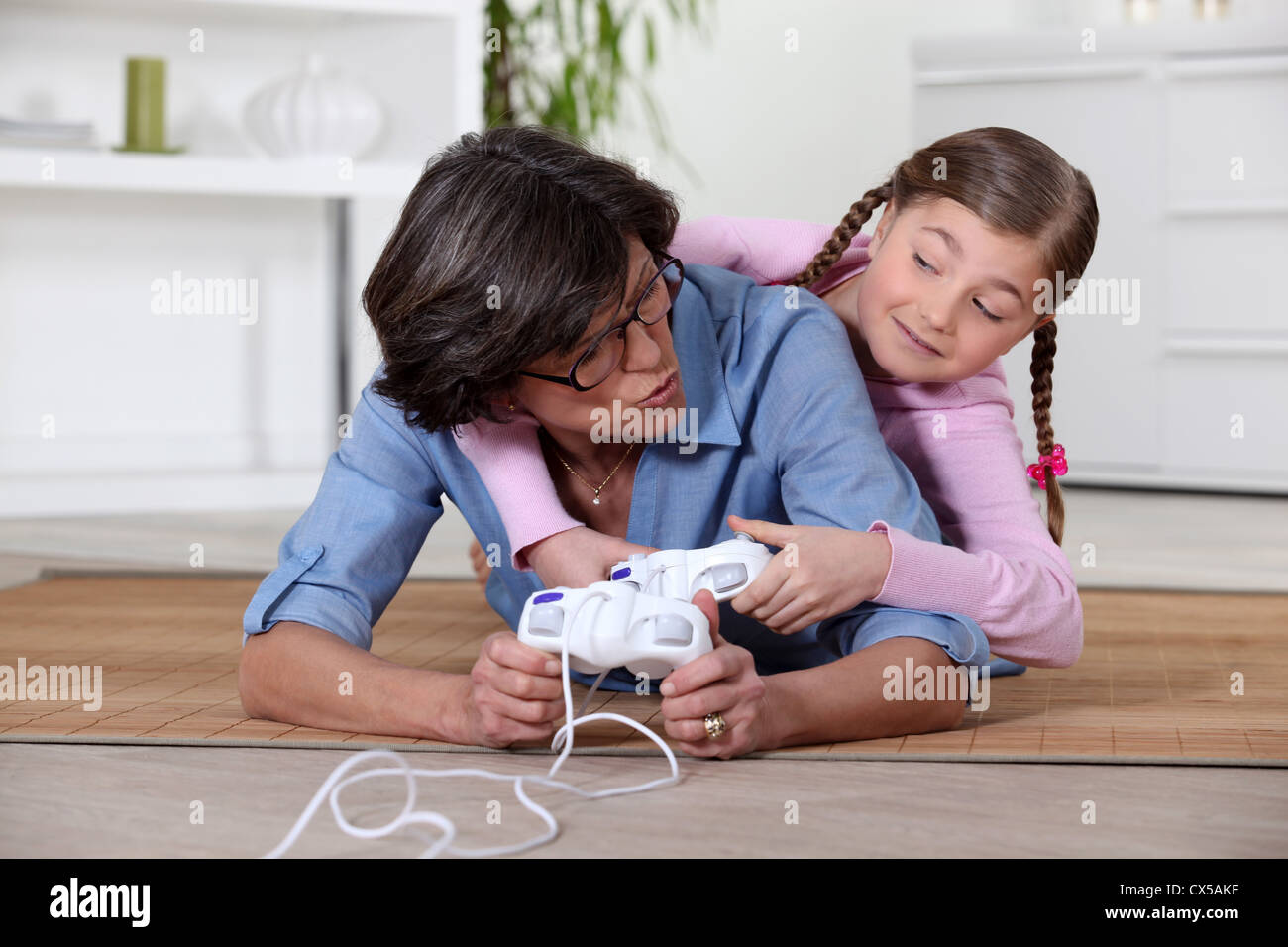 Mother and daughter playing video games Stock Photo - Alamy