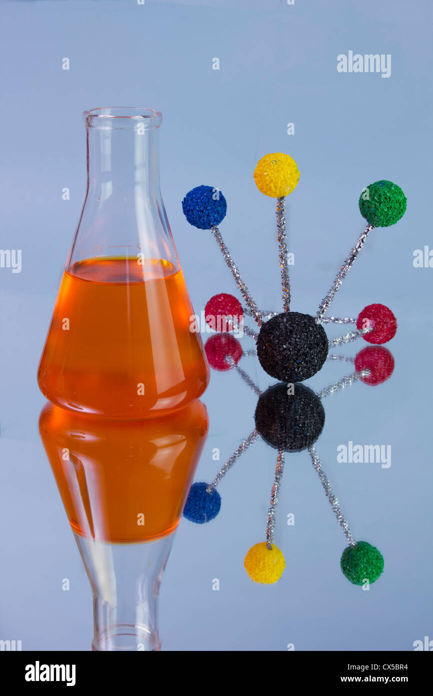 orange chemistry flask with molecular model and reflections Stock Photo ...