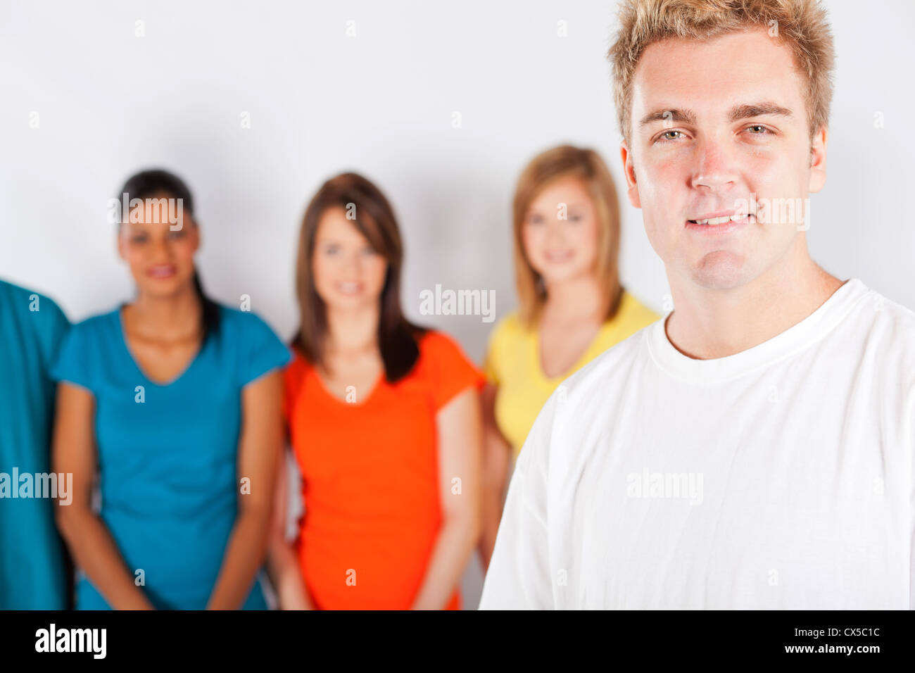 young man in front of group of people Stock Photo - Alamy