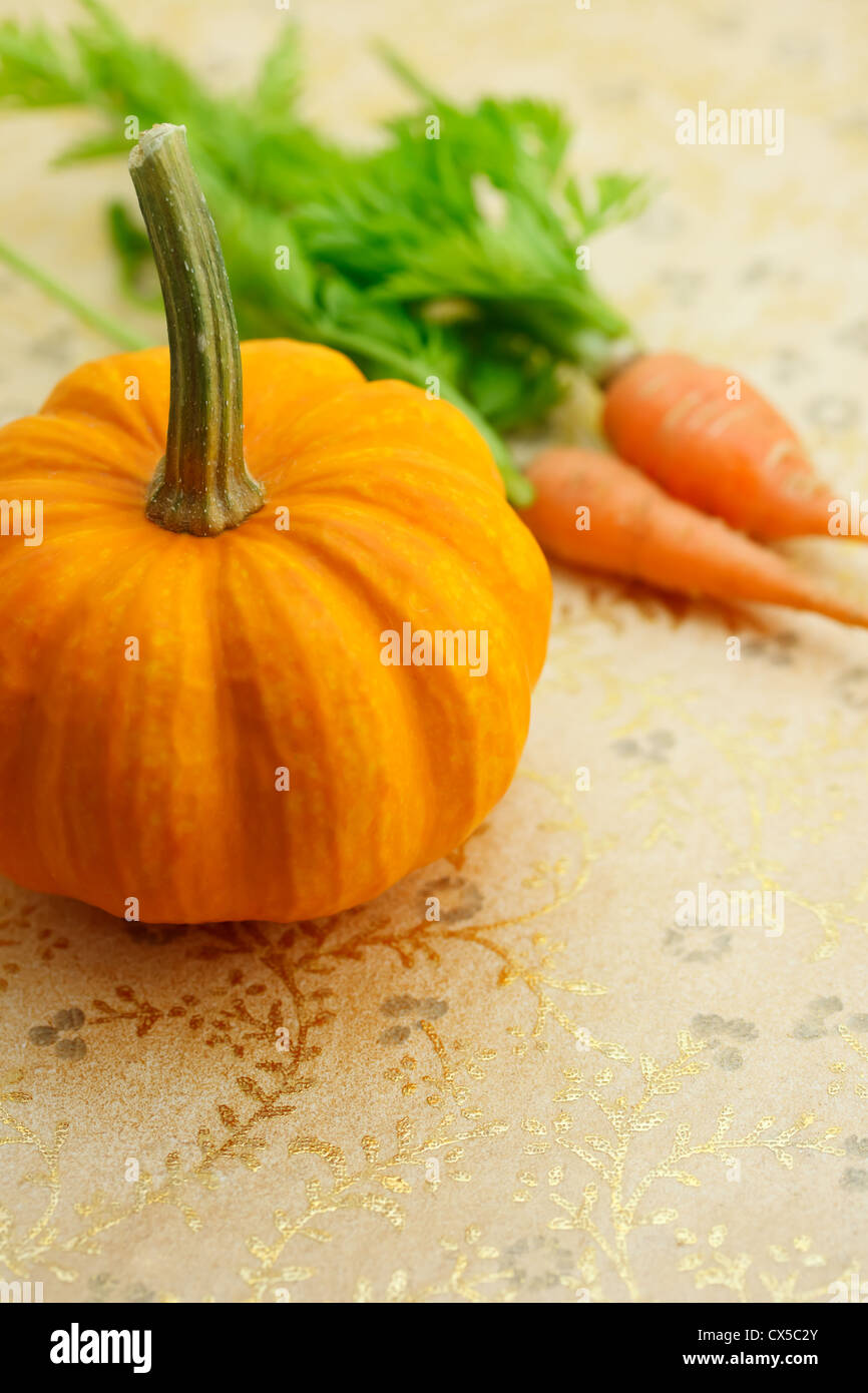Orange miniature pumpkin with carrots Stock Photo - Alamy