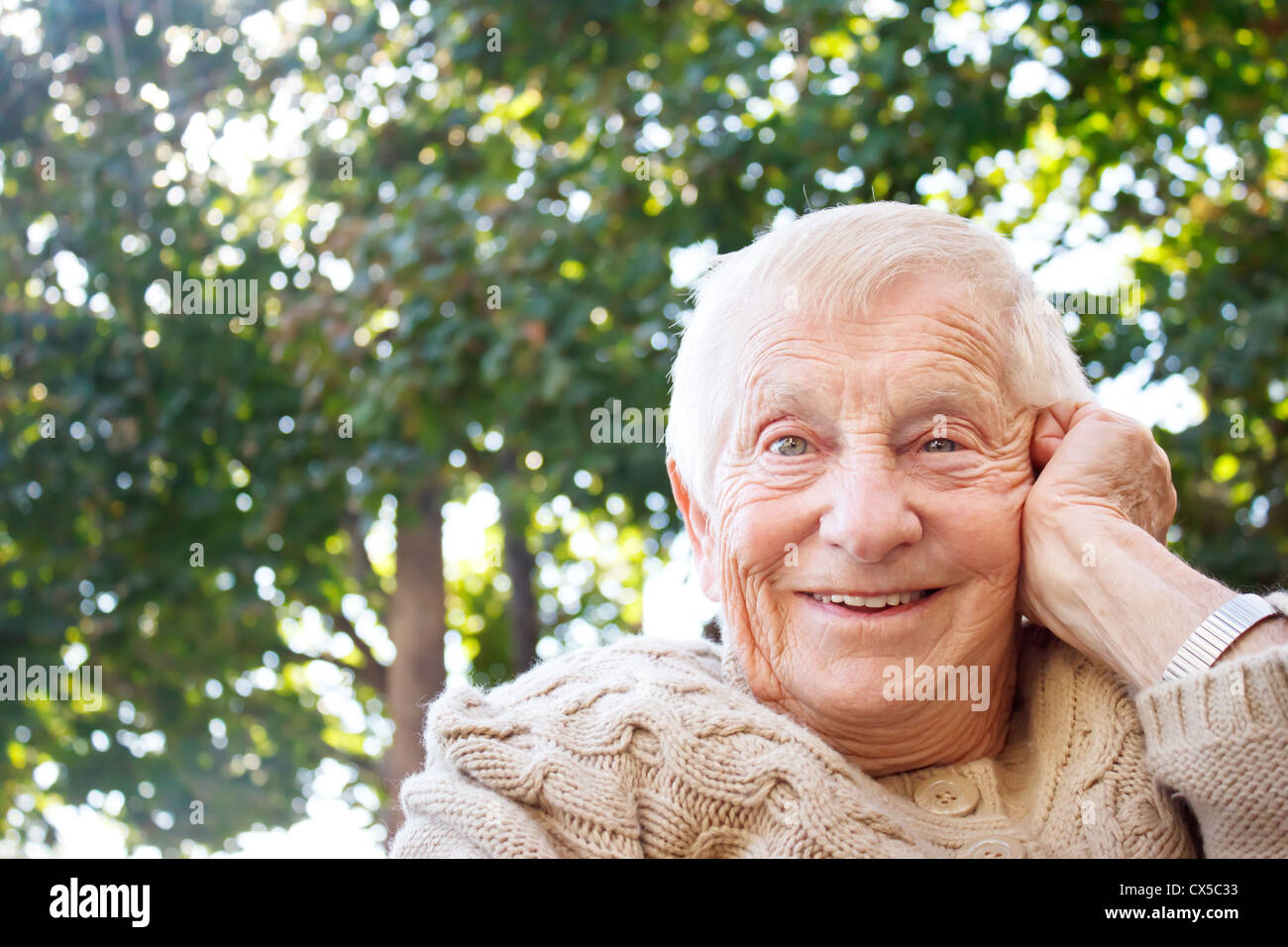 Happy senior lady smiling outside Stock Photo - Alamy