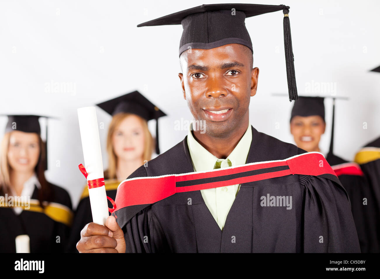 male African graduate at university graduation with classmates Stock ...
