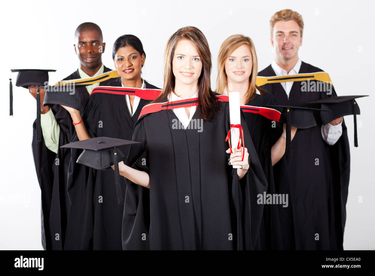 group of multiracial graduates at graduation holding caps Stock Photo ...