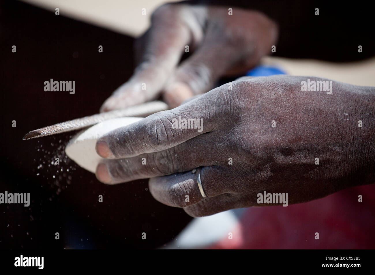 African hands working a stone Stock Photo - Alamy
