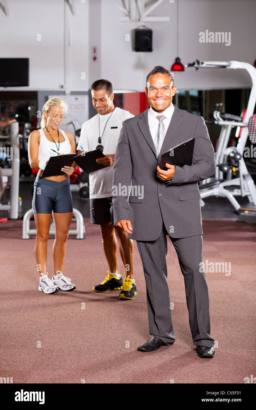 happy gym manager and trainers inside gym Stock Photo - Alamy