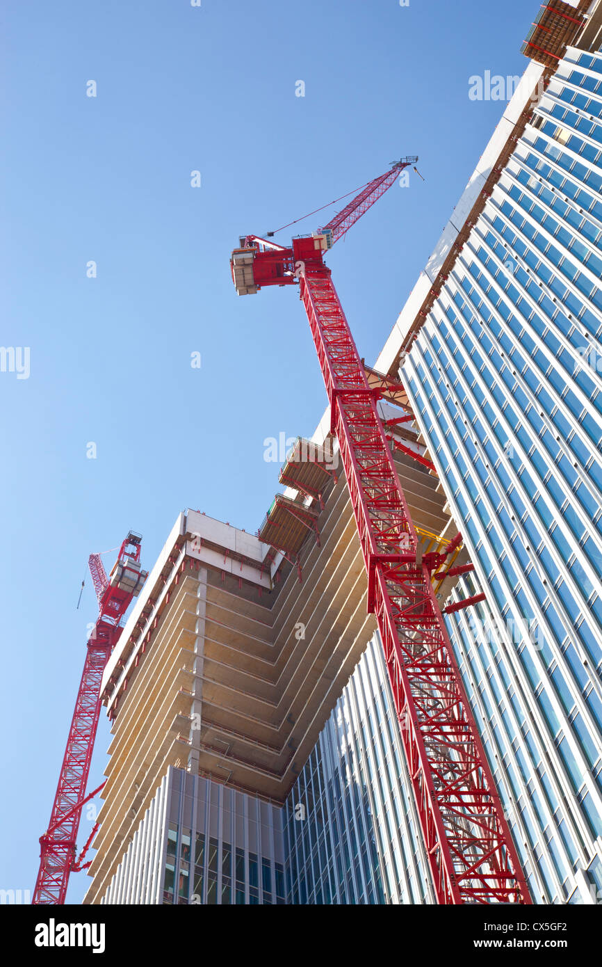 High-rise construction cranes and unfinished office Stock Photo - Alamy