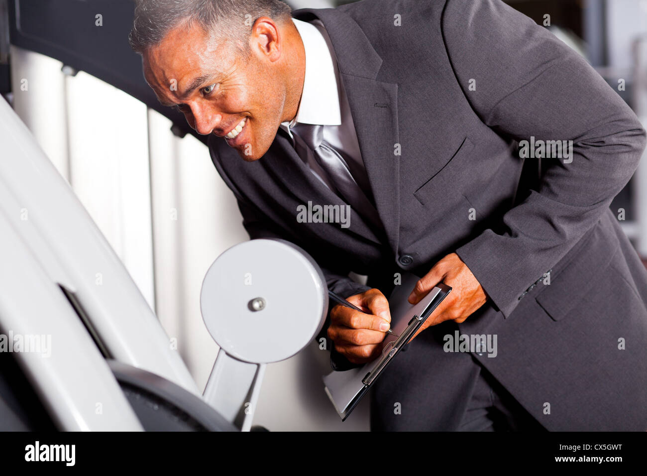 gym manager registering gym equipment Stock Photo - Alamy