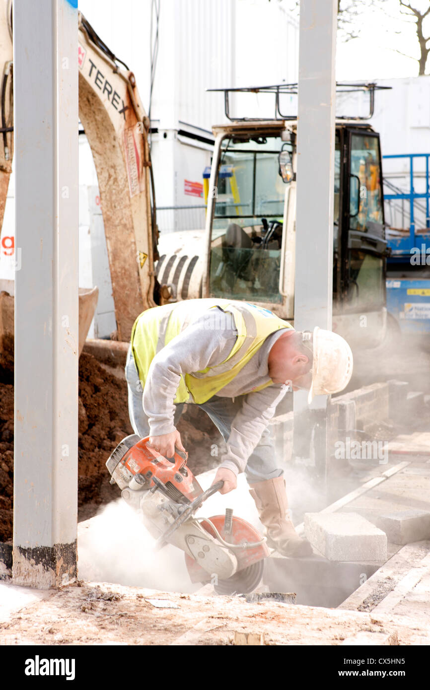 Builder cutting concrete Stock Photo - Alamy