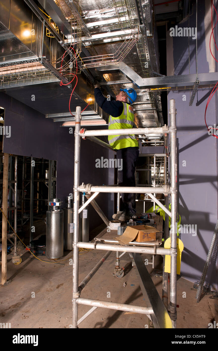 Electrician on scaffolding platform installing hi-res stock photography ...