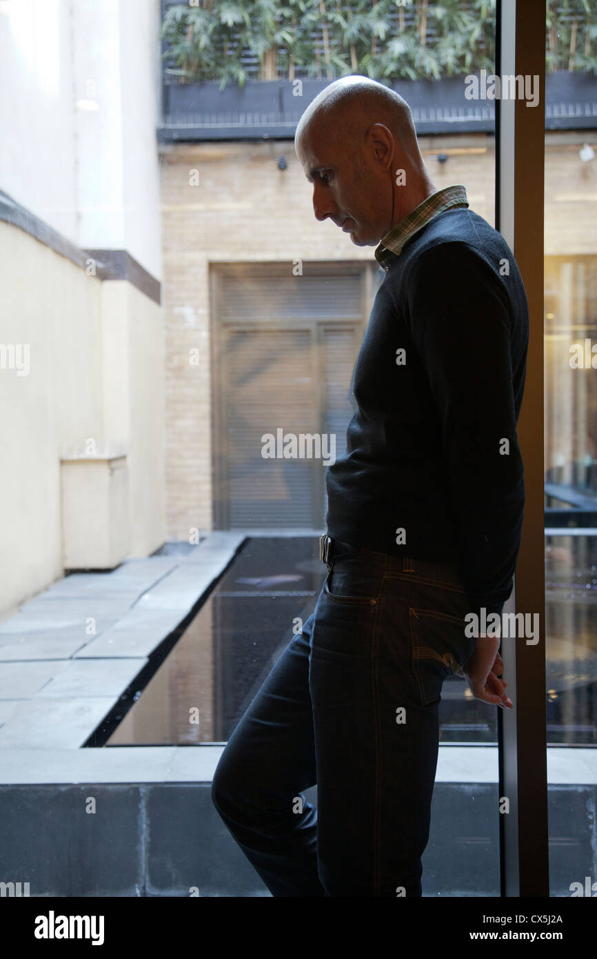 Man leaning against glass doors hi-res stock photography and images - Alamy