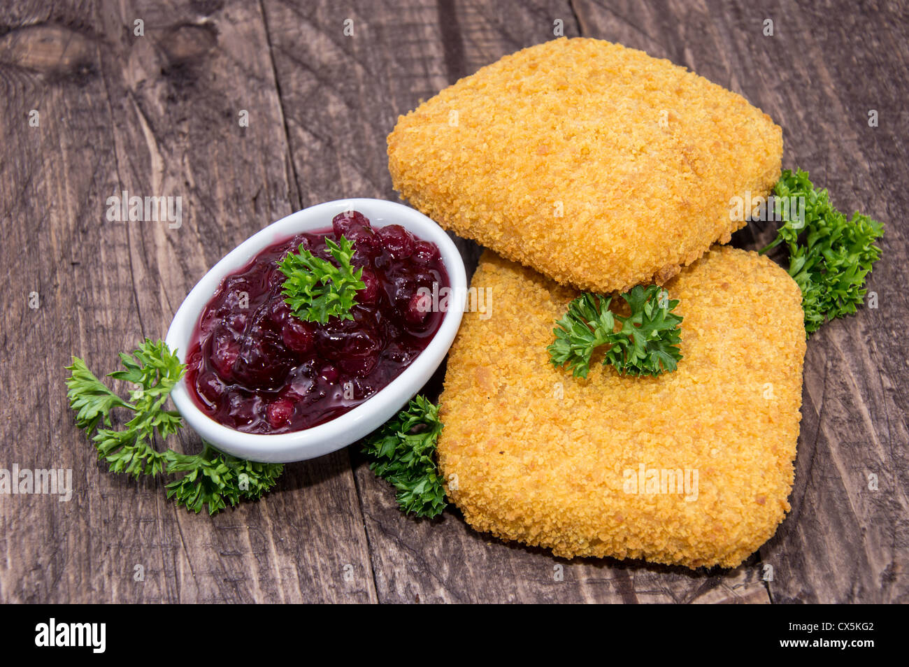 Portion of fried Gouda on wooden background Stock Photo - Alamy