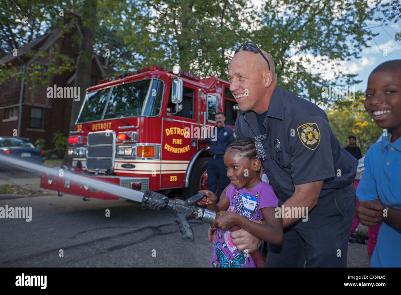 Fire Fighters with Children at a Detroit Block Party Stock Photo - Alamy