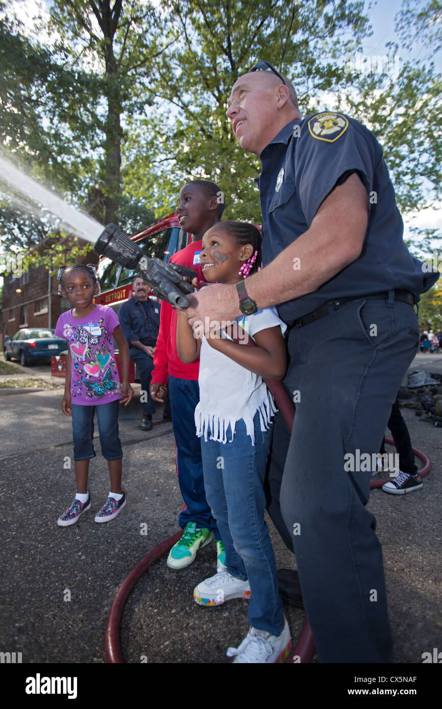 Fire Fighters with Children at a Detroit Block Party Stock Photo - Alamy